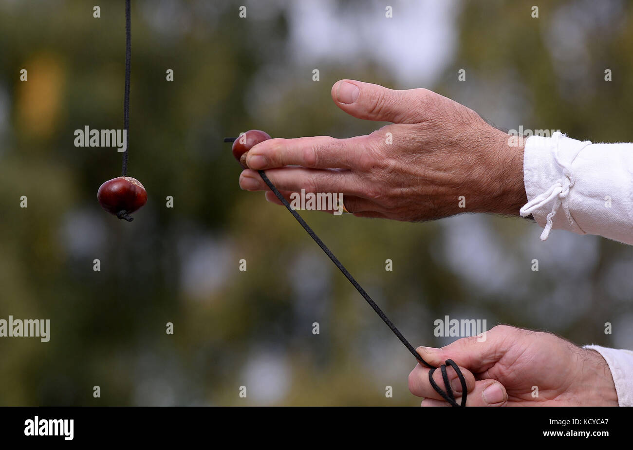 A competitor takes part in the annual World Conker Championships to ...