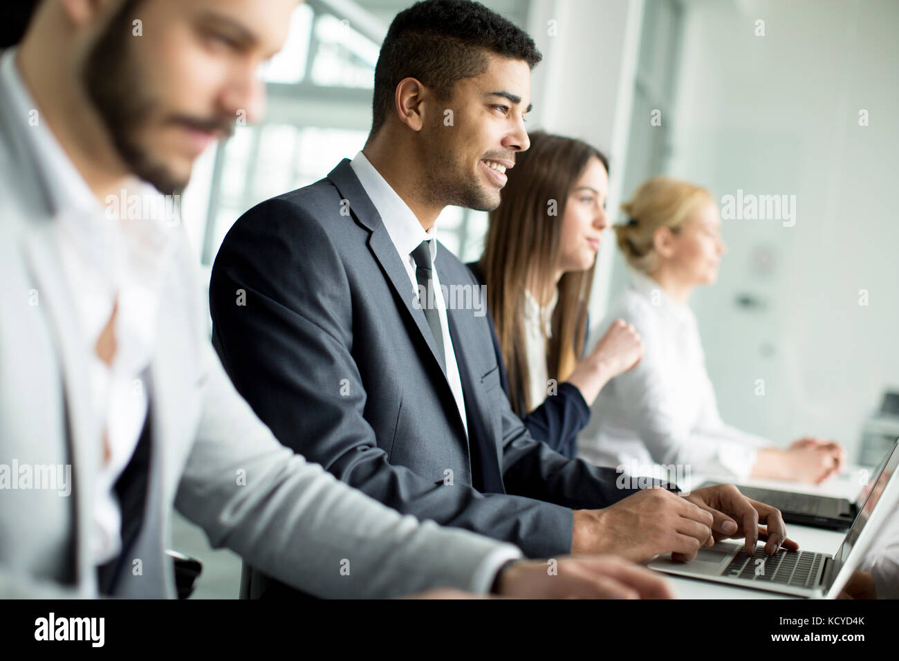 Business team working together in modern office to achieve better ...