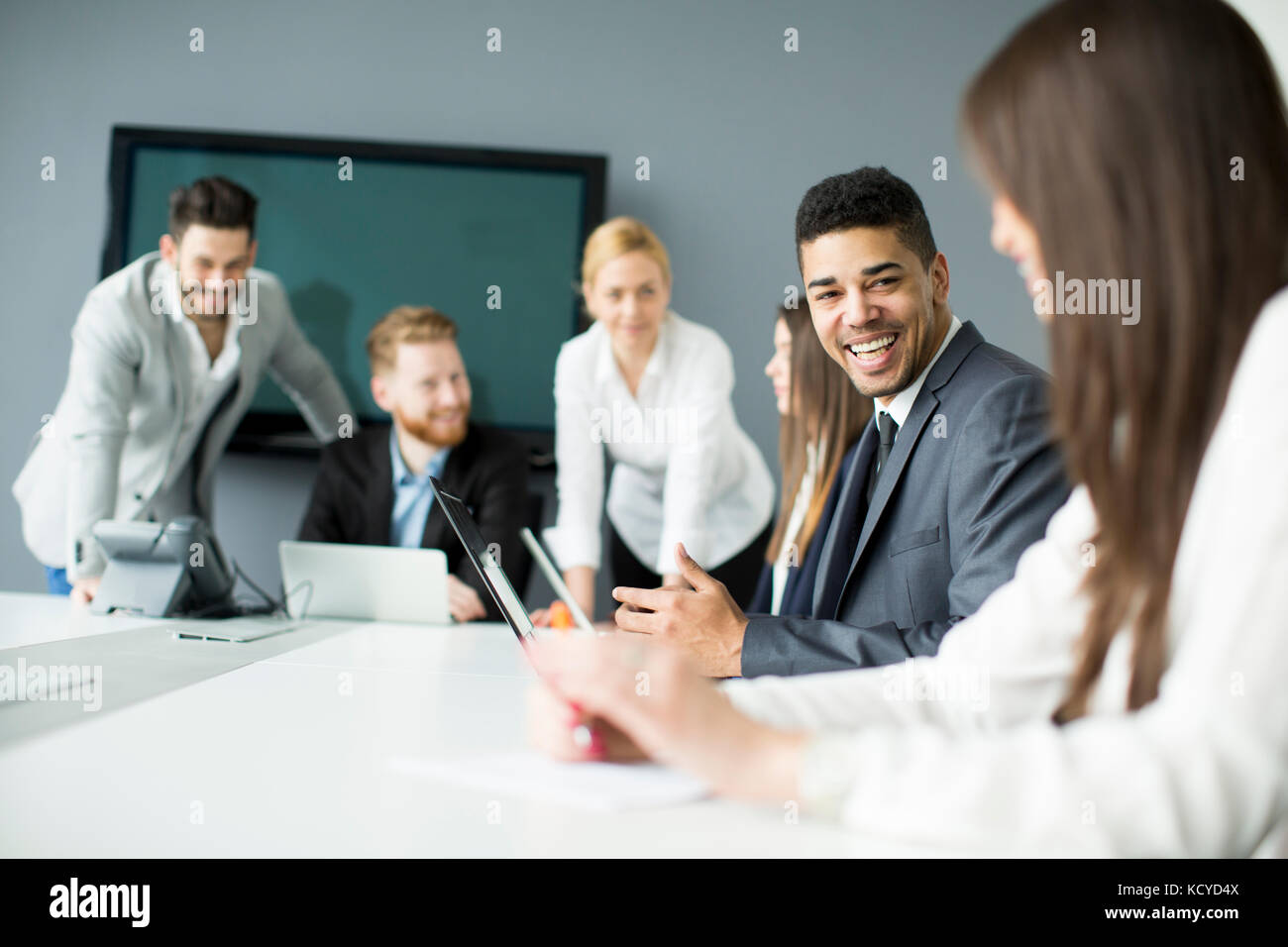 Business team working together in modern office to achieve better ...