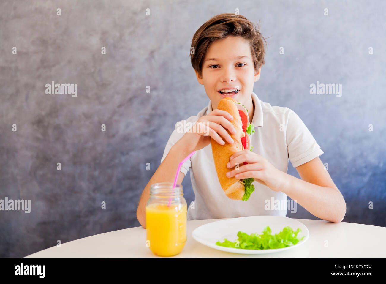 Portrait of cute teen boy having healthy breakfast at home Stock Photo ...