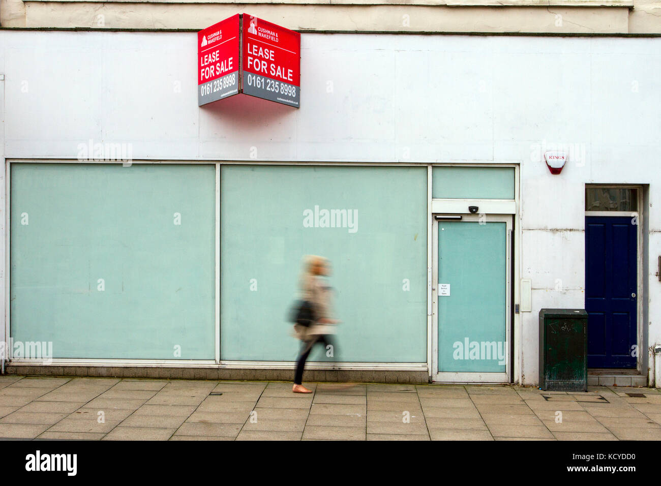 Out of focus figures passing closed down shops. Businesses in decline ...