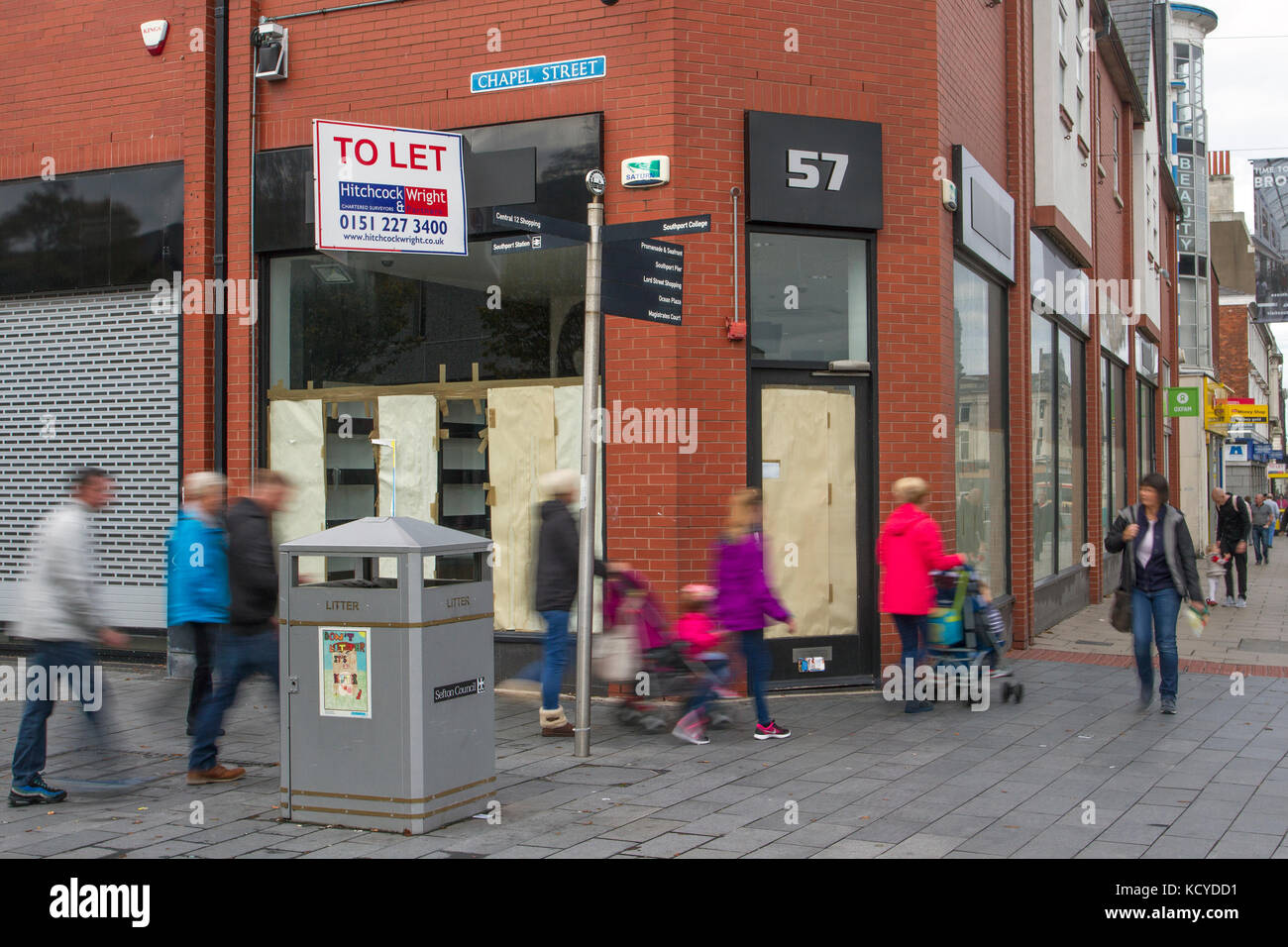 Out of focus figures passing, Businesses in decline, Central business ...