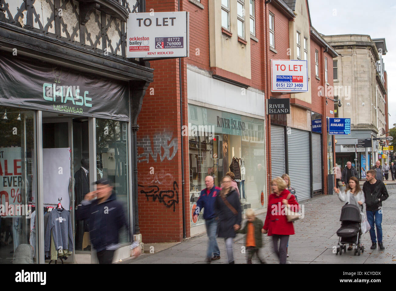 Out of focus figures passing, Businesses in decline, Central business ...