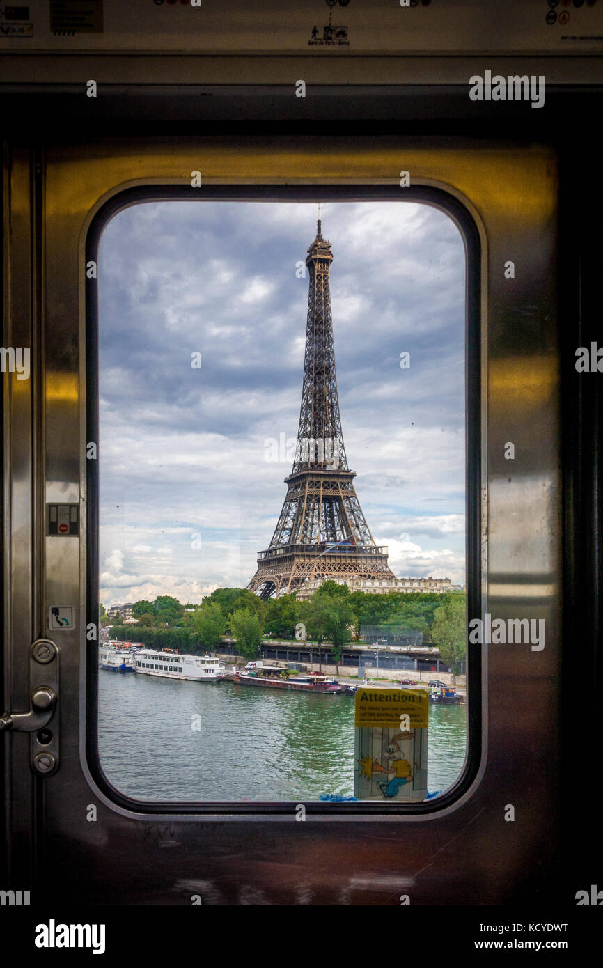 The Eiffel Tower is framed by a window on a metro train. Paris, France ...