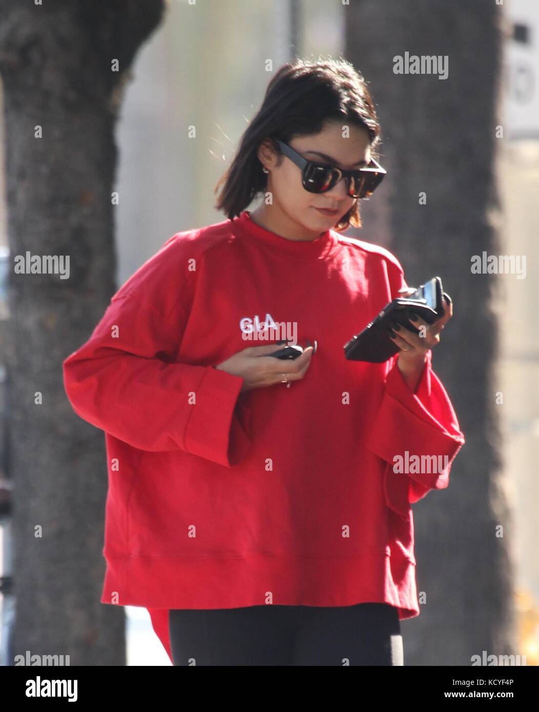 Vanessa Hudgens busy on her cell phone as she arrives for her pilates ...