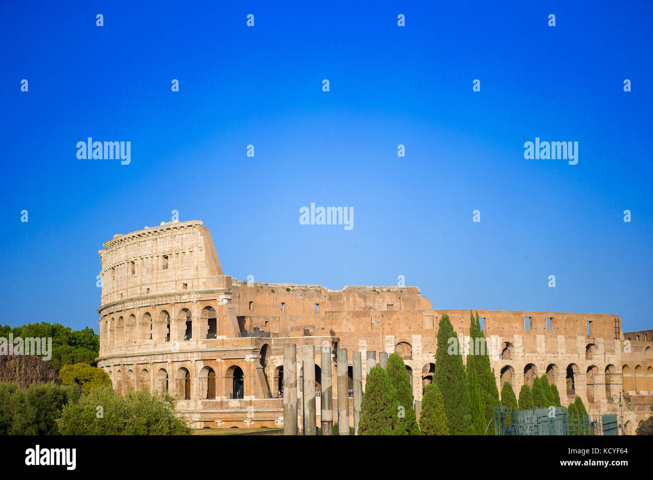 Colosseum background blue sky in Rome, Italy Stock Photo - Alamy