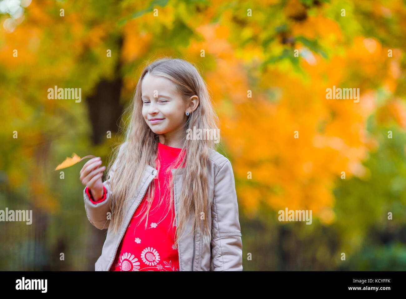 Adorable little girl at beautiful autumn day outdoors Stock Photo - Alamy