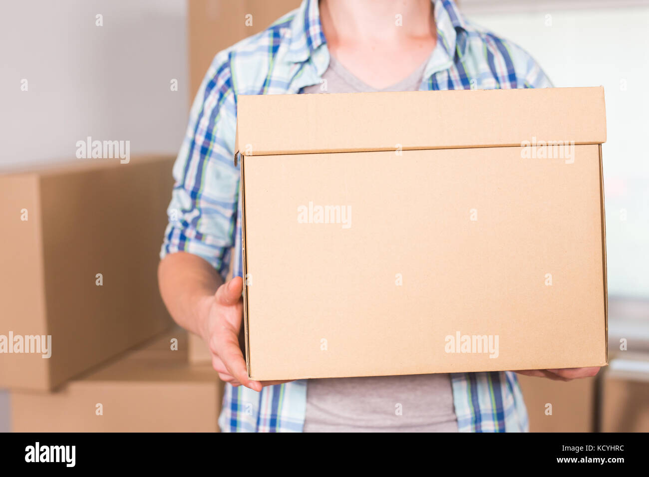 delivery, mail and people concept - close up of man with cardboard box ...