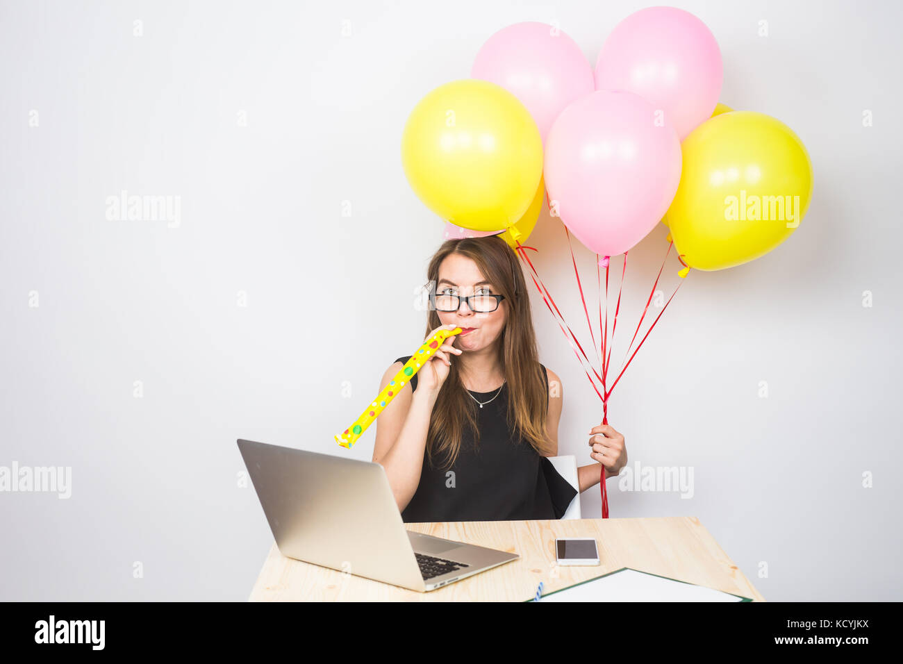 Funny young woman celebrating the success of her business or a birthday ...