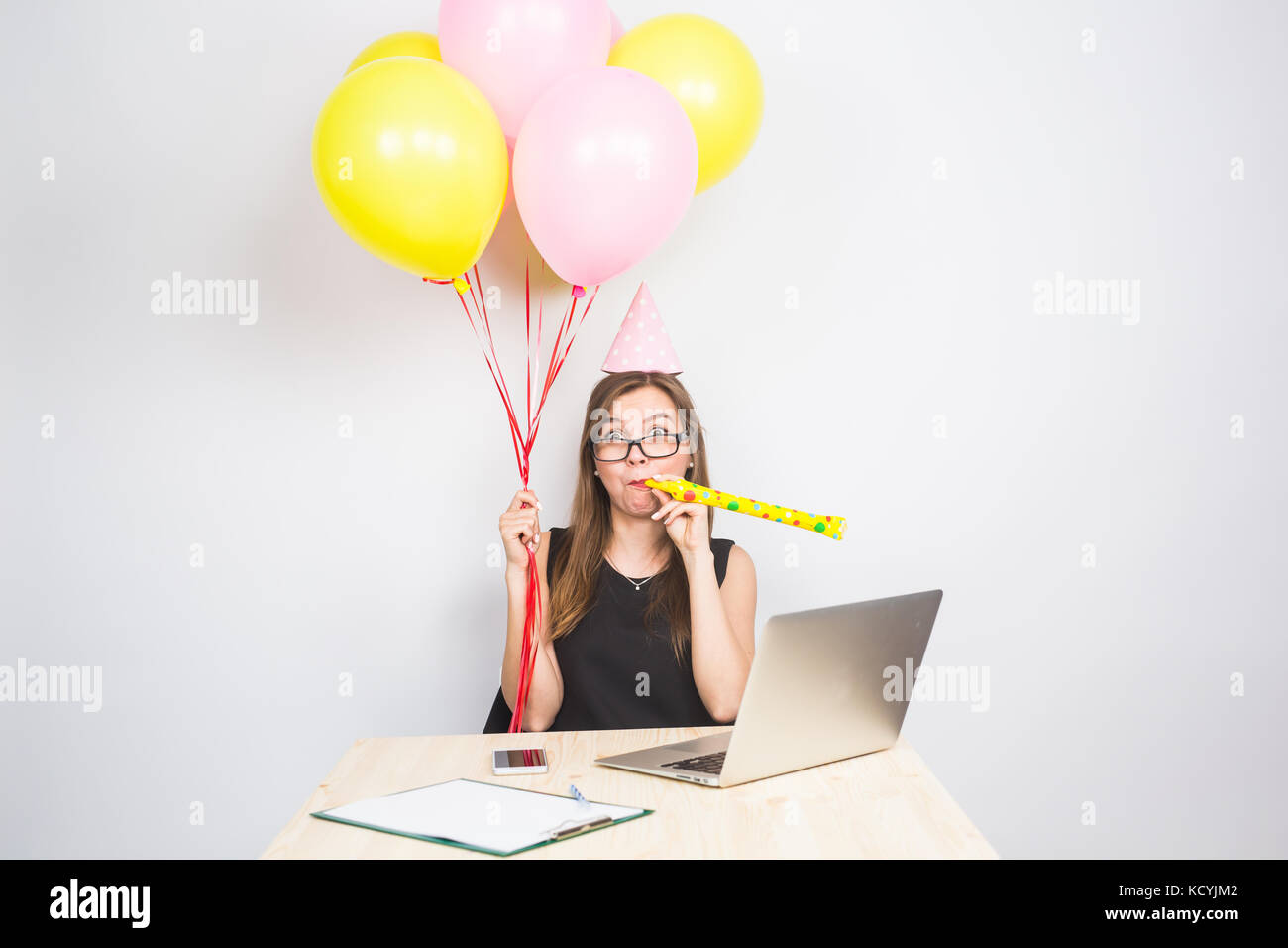 Funny young woman celebrating the success of her business or a birthday ...