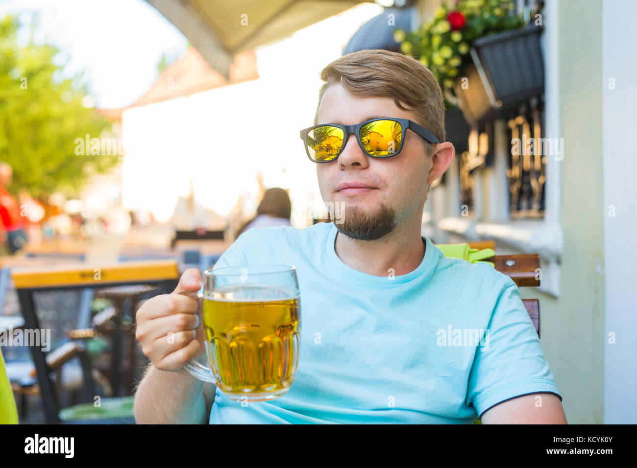 Man drinking beer. Handsome young hipster man drinking beer while ...