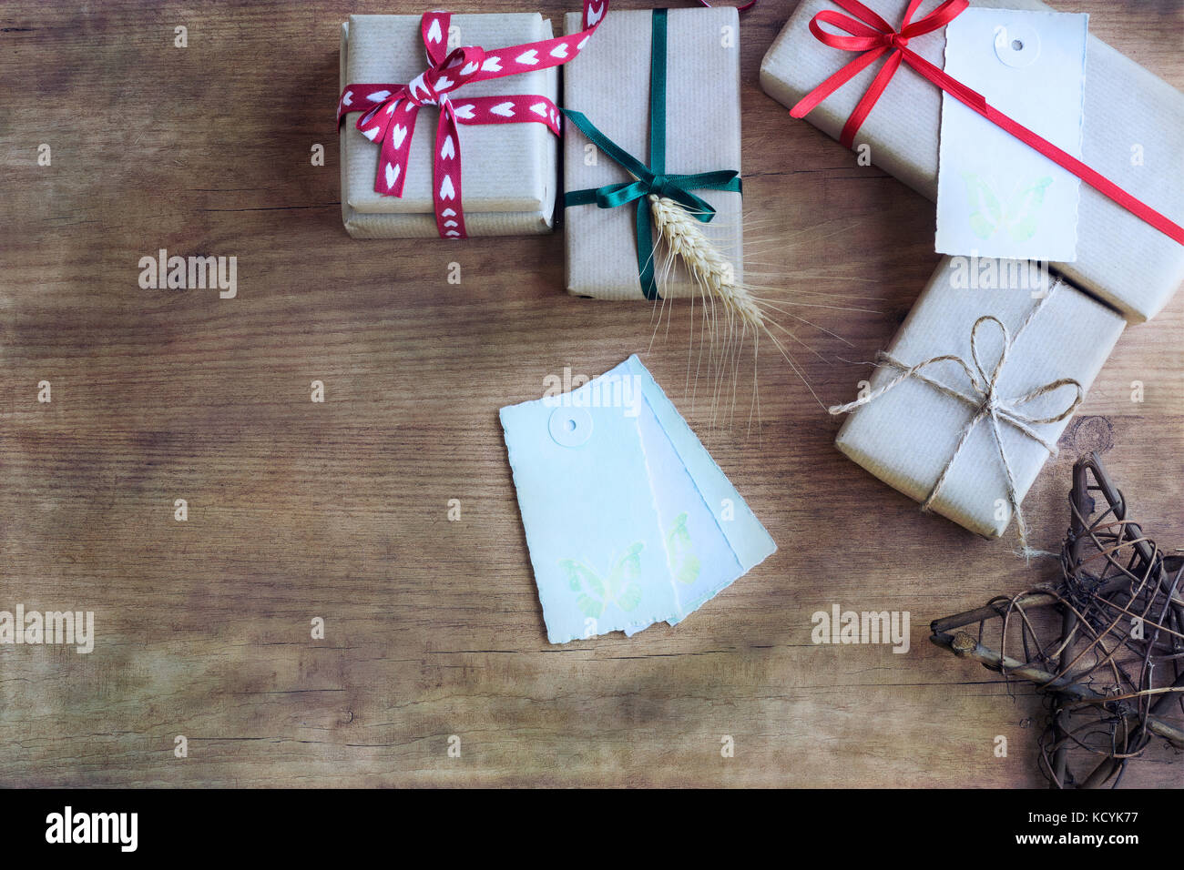 Gift boxes wrapped in rustic paper and design ribbons on abstract ...