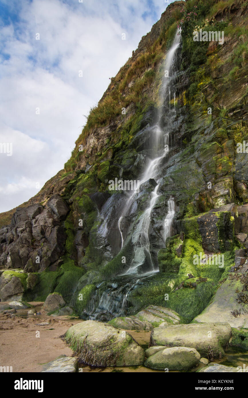 Waterfall on the cliffs edge in Tresaith, Wales, UK Stock Photo - Alamy