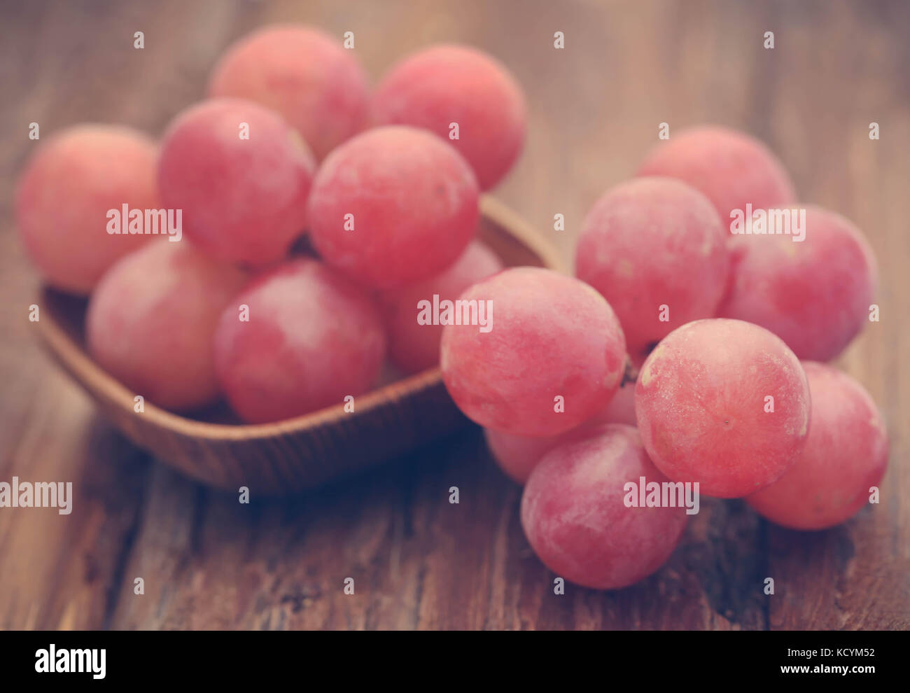 Organic red grapes in textured natural surface Stock Photo - Alamy