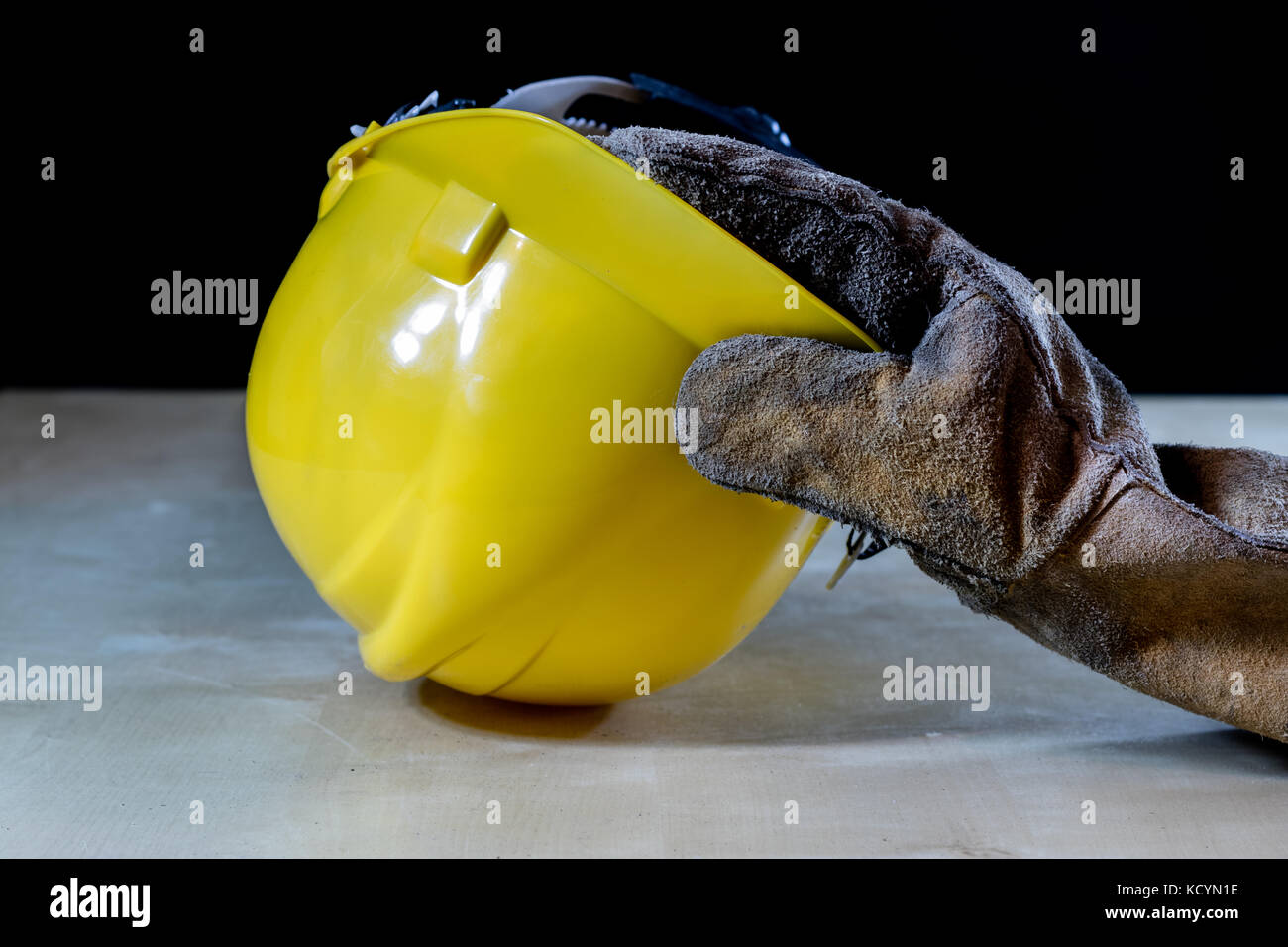 Hand in glove with tool for work in workshop. Hand protected by working ...