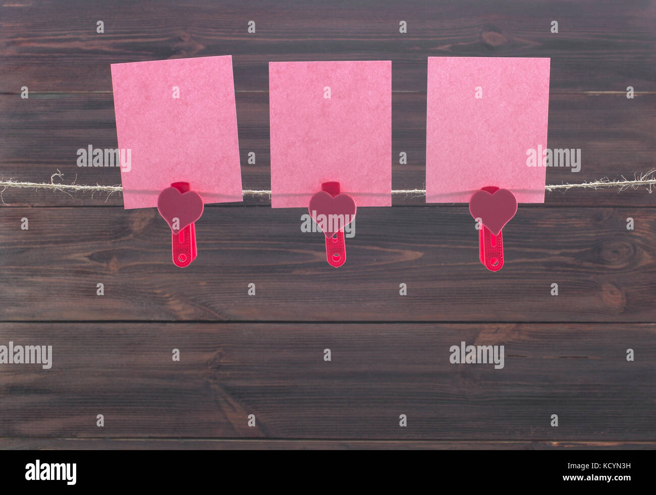 sheets on rope on wooden background Stock Photo - Alamy