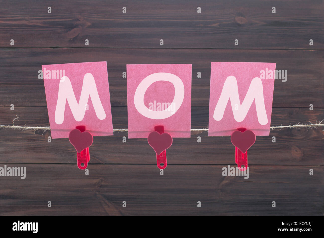 sheets on rope on wooden background Stock Photo - Alamy