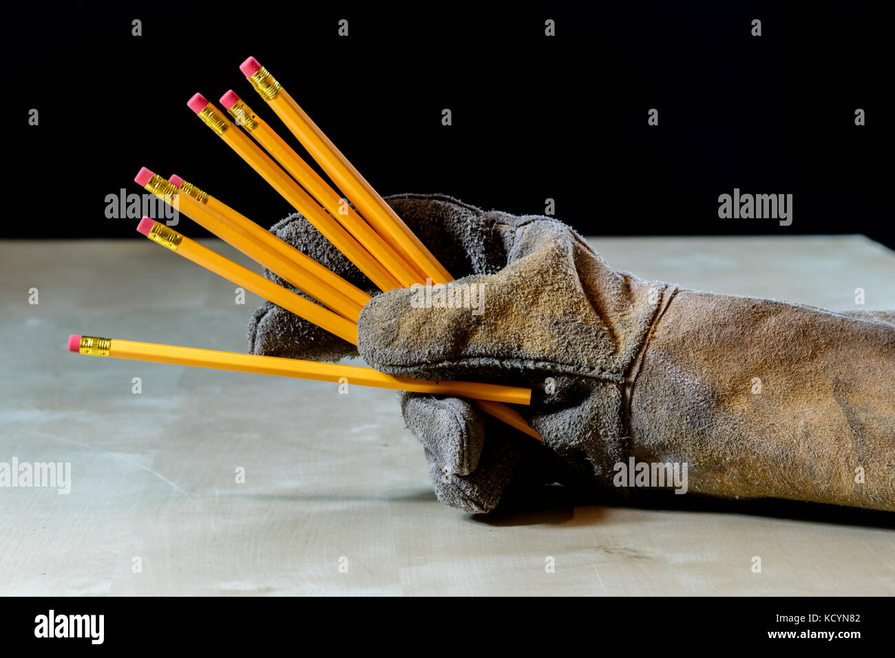 Hand in glove with tool for work in workshop. Hand protected by working ...