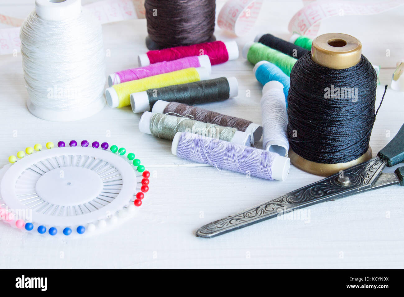 Sewing tools on a wooden background Stock Photo - Alamy
