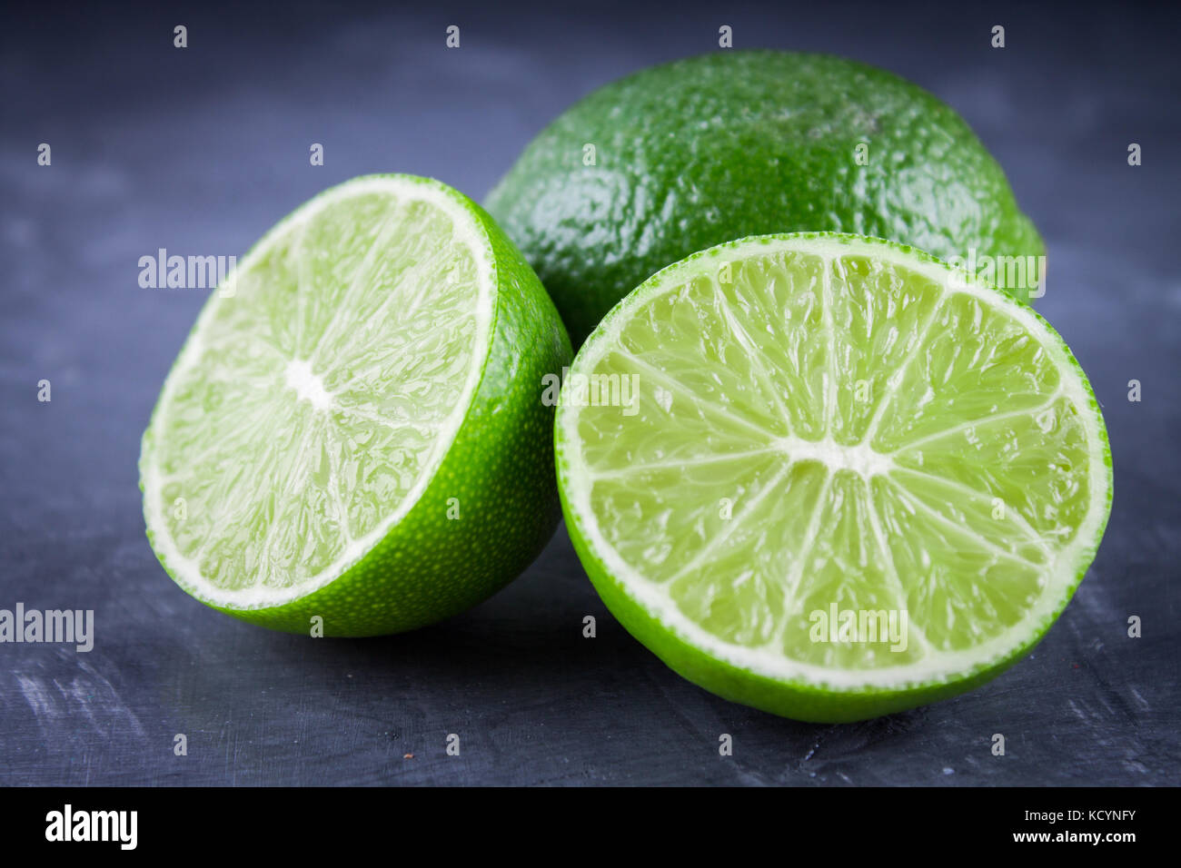 lemons and limes on a gray background Stock Photo - Alamy