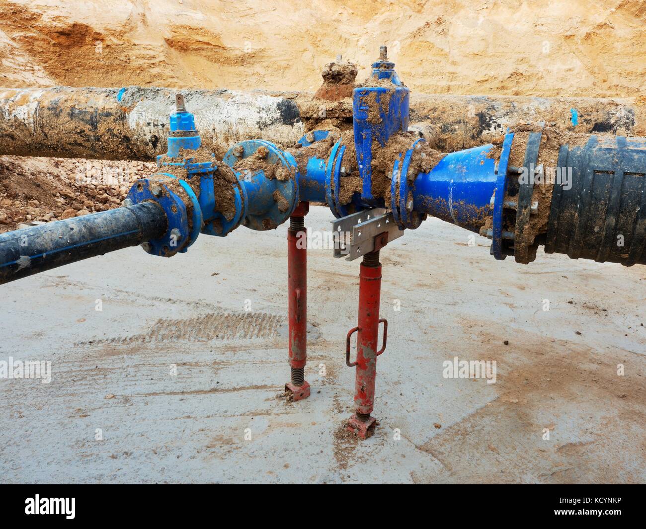 Old big drink water pipes joined with new blue gate valves and ...
