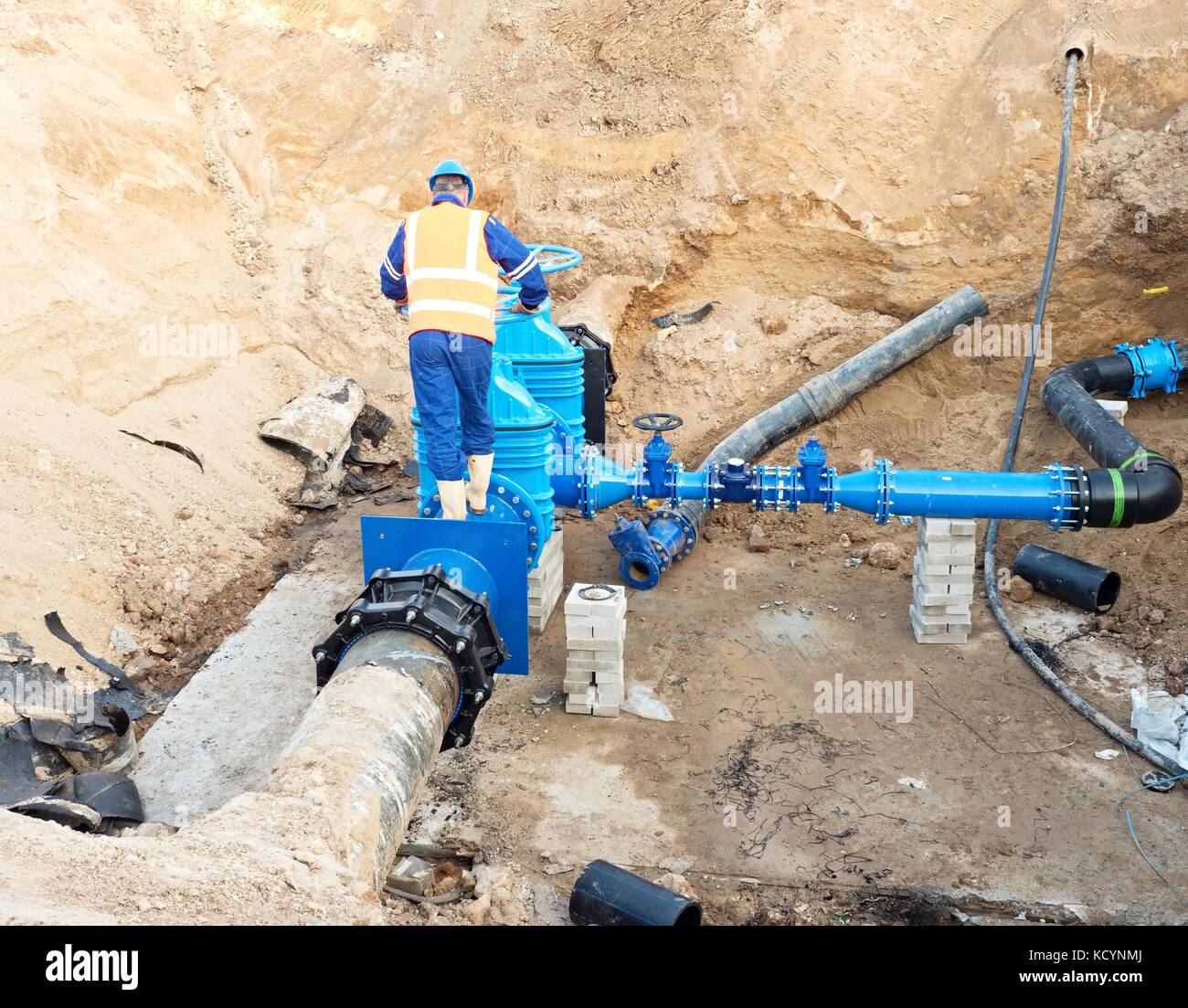 Worker works underground for reconstrucion of drink water system ...