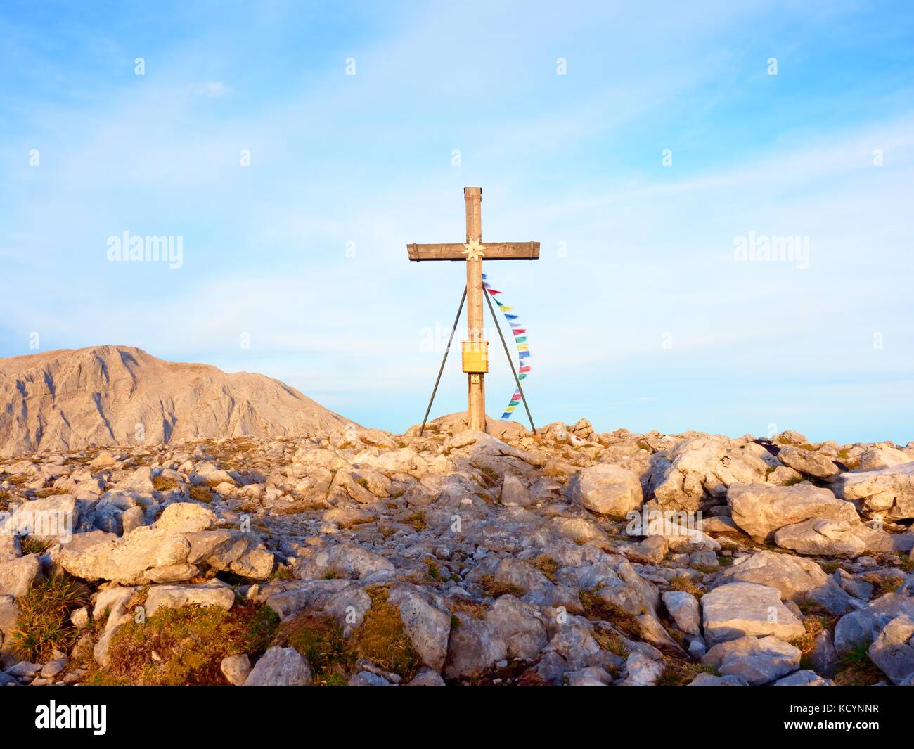Big cross on top of mountain as typical in the Alps. Wooden cross at ...