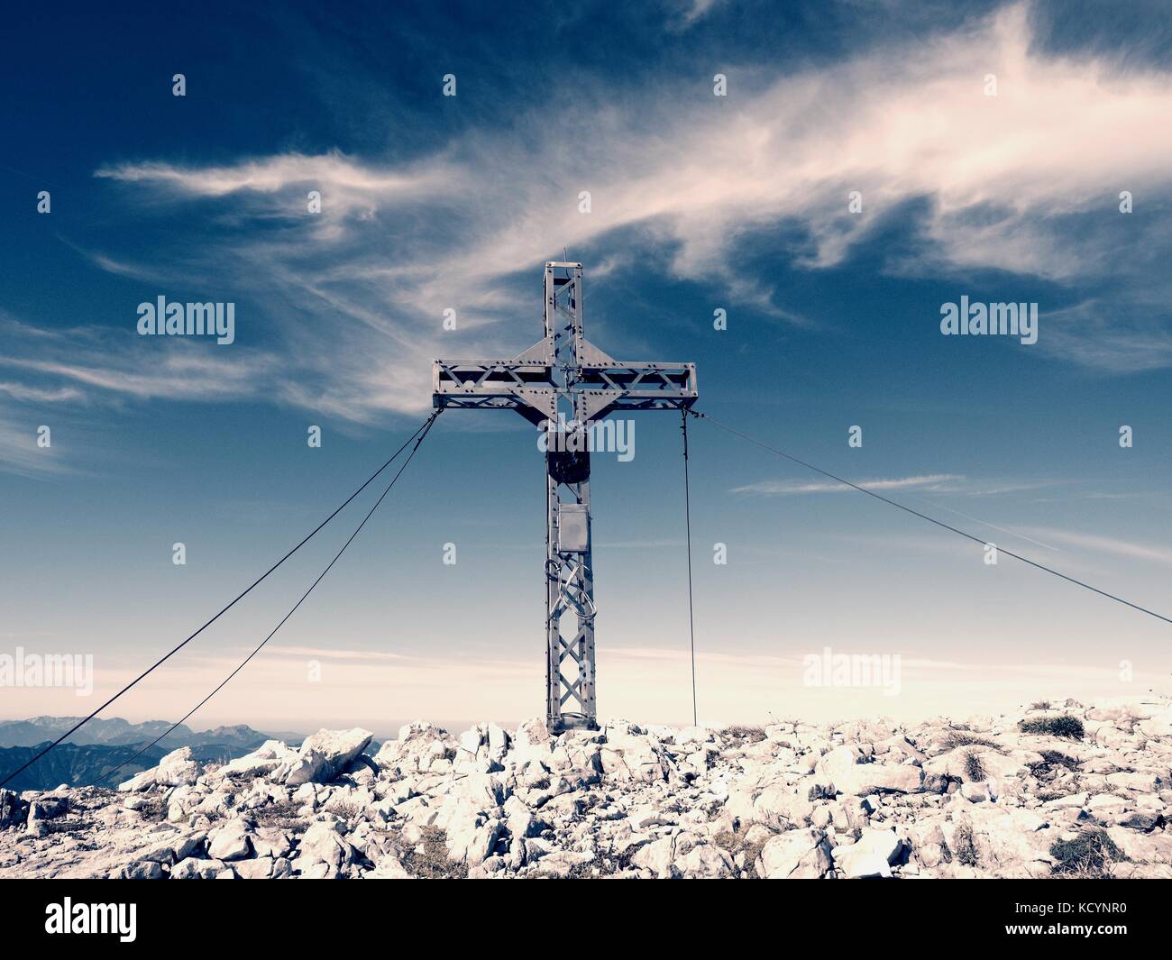 Praying summit cross on high rocky mountain. Steel artistic crucifix on ...