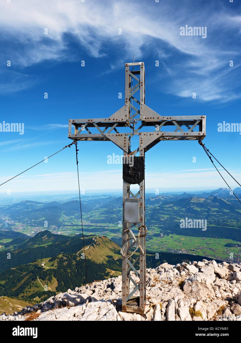Praying summit cross on high rocky mountain. Steel artistic crucifix on ...