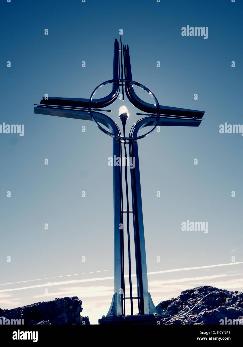 Praying summit cross on high rocky mountain. Steel artistic crucifix on ...