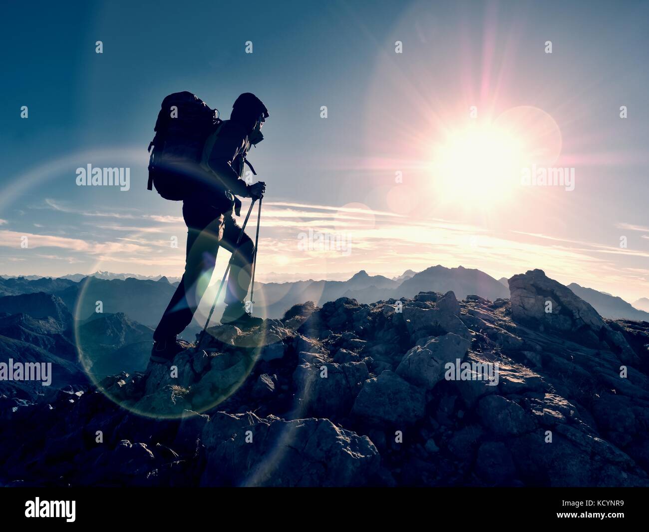 Lens flare light, strong defect. Tourist guide on trekking path with ...