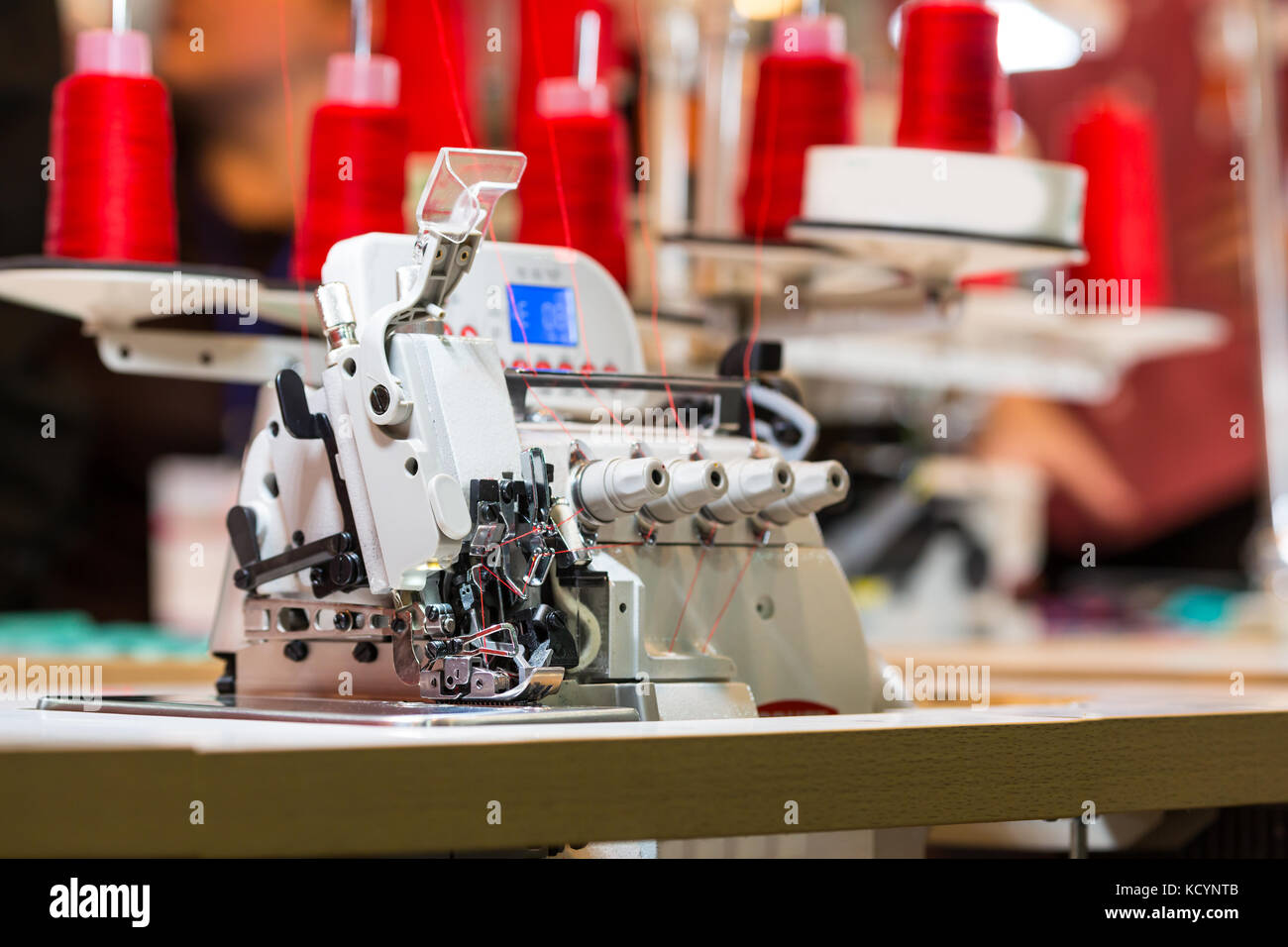 Overlock machine on sewing factory, nobody. Clothing sew. Textile ...