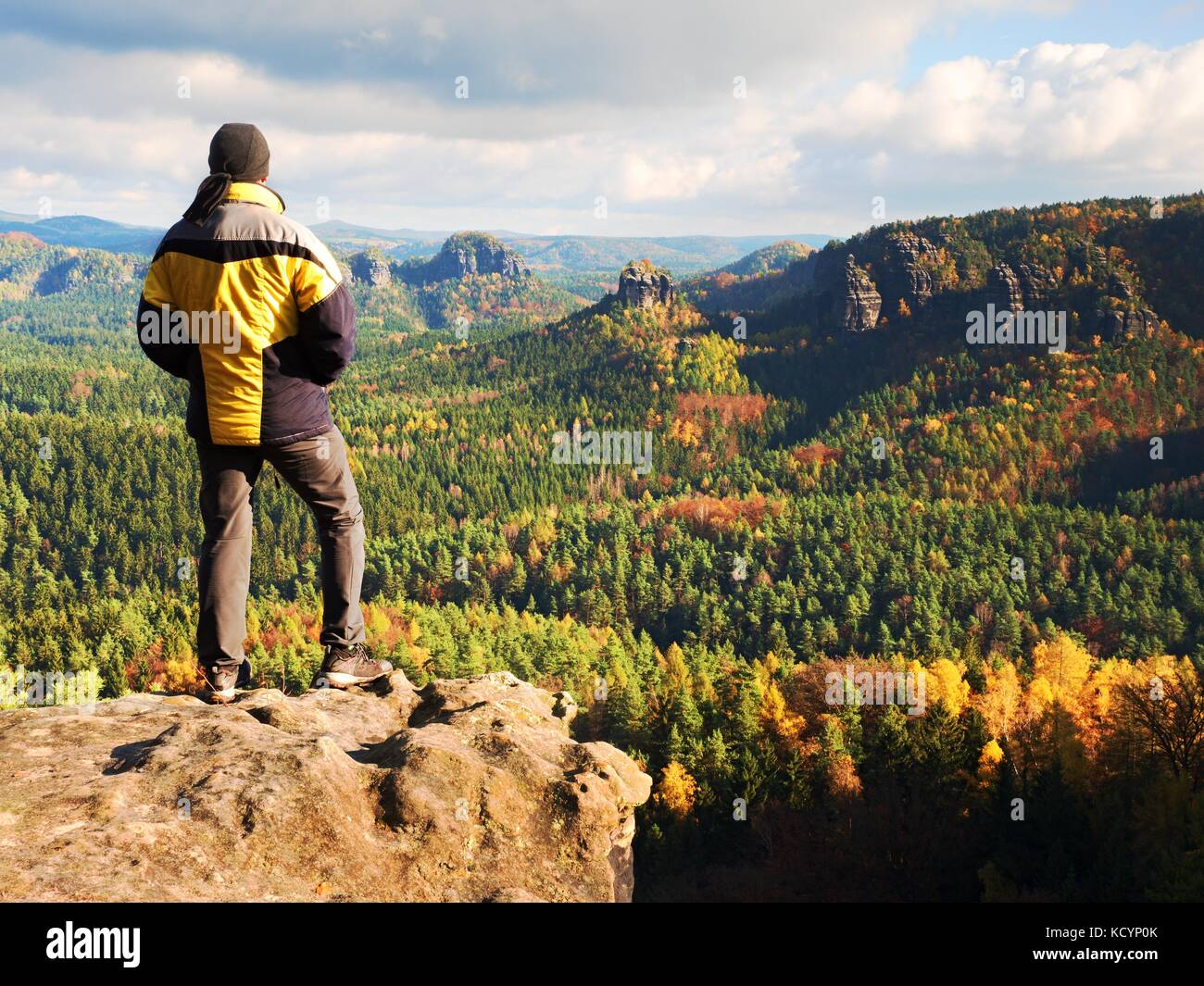 Man stay on sharp rock peak. Satisfy hiker enjoy view. Tall man on ...