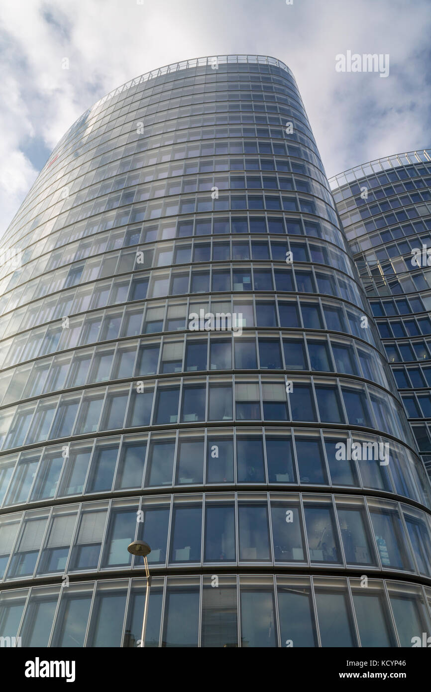 Glass modern building on a blue cloudy sky Stock Photo - Alamy