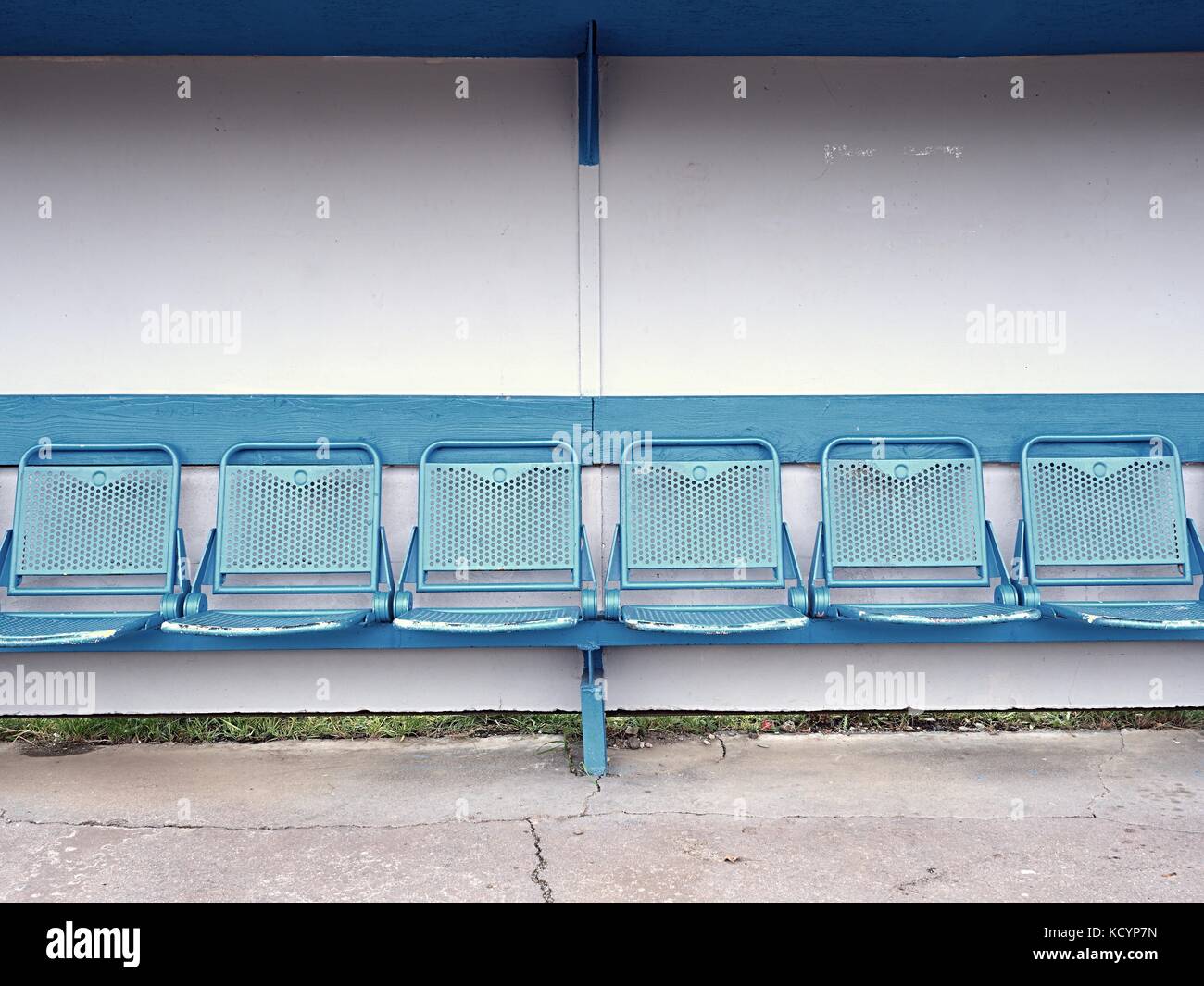 New blue metal seats on outdoor stadium players bench, chairs with blue ...