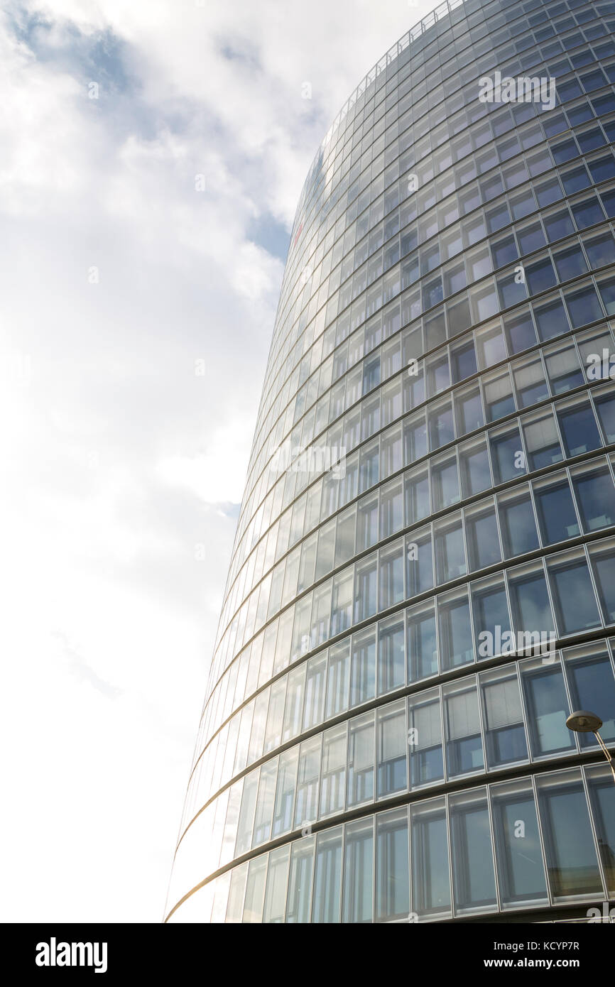 Glass modern building on a blue cloudy sky Stock Photo - Alamy