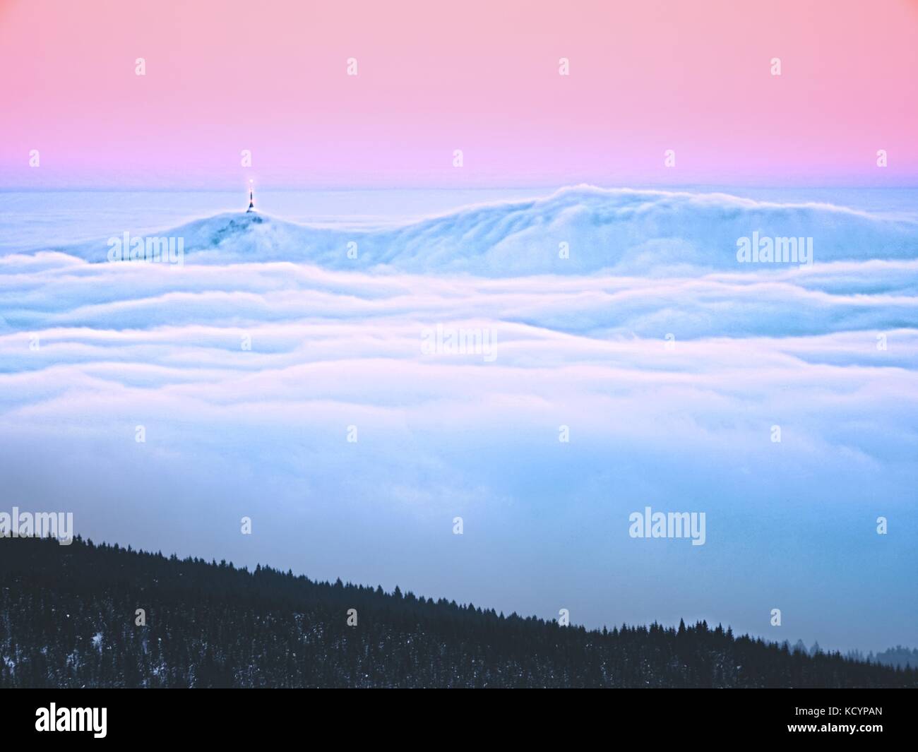 Far mountain peak with observatory above creamy mist. Shinning lights ...