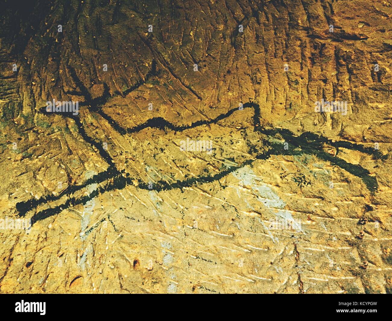 Caveman symbols on sandstone wall. Paint of human hunting, prehistoric ...