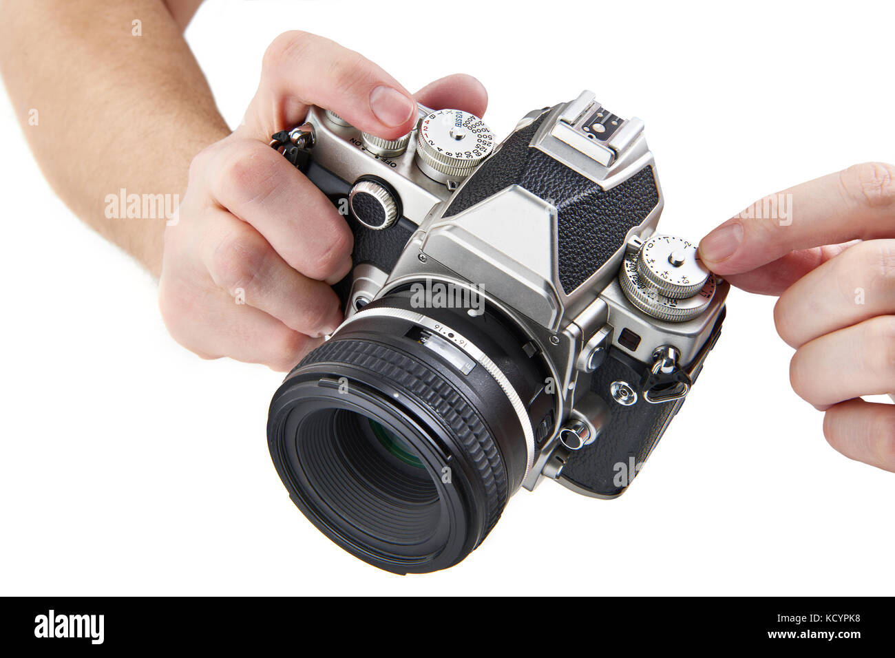 Retro SLR camera in the hands of the photographer isolated closeup ...