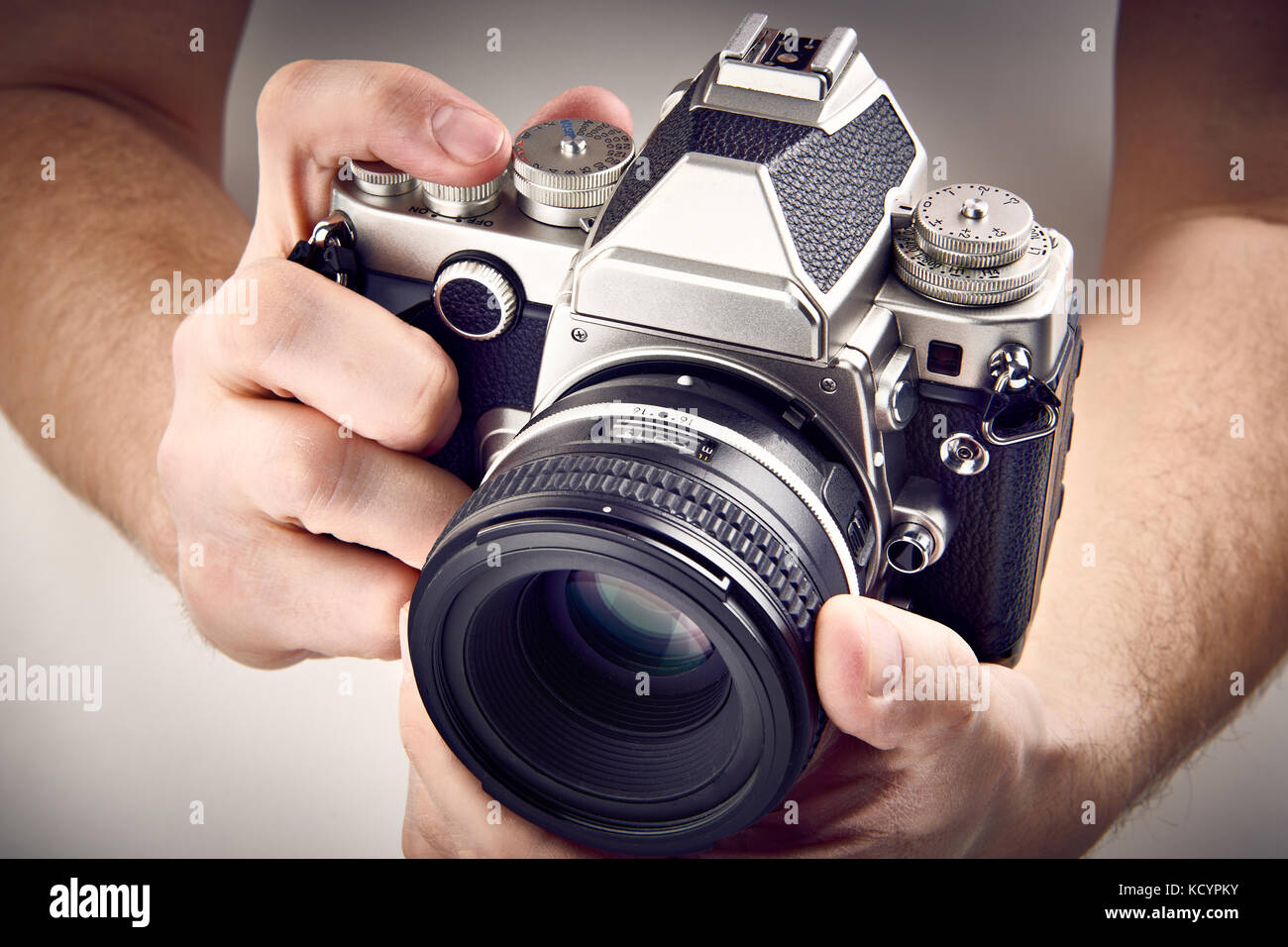 Retro SLR camera in the hands of the photographer closeup Stock Photo ...