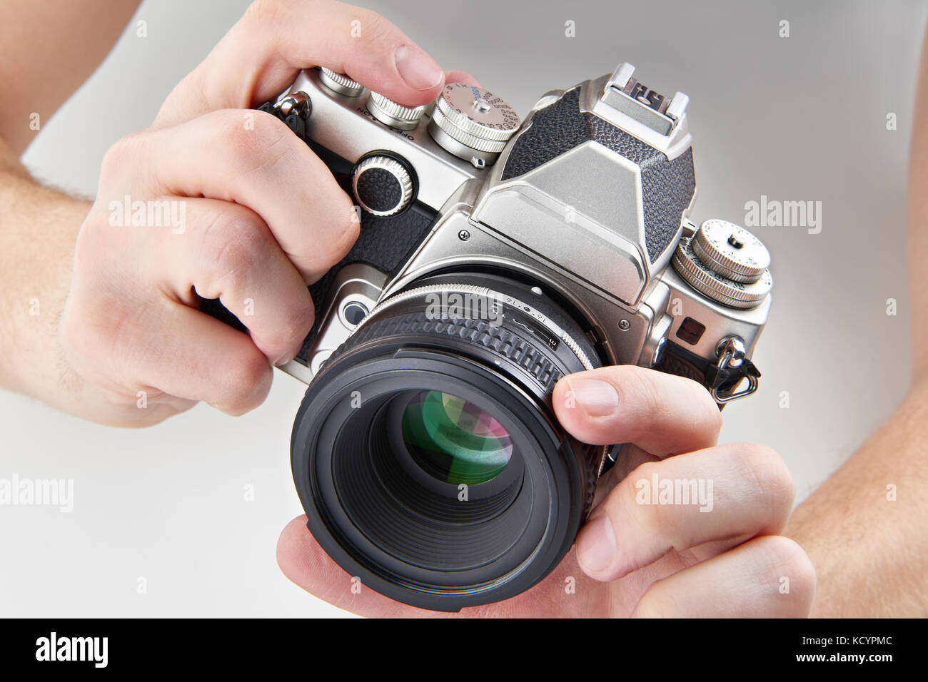Retro SLR camera in the hands of the photographer closeup Stock Photo ...