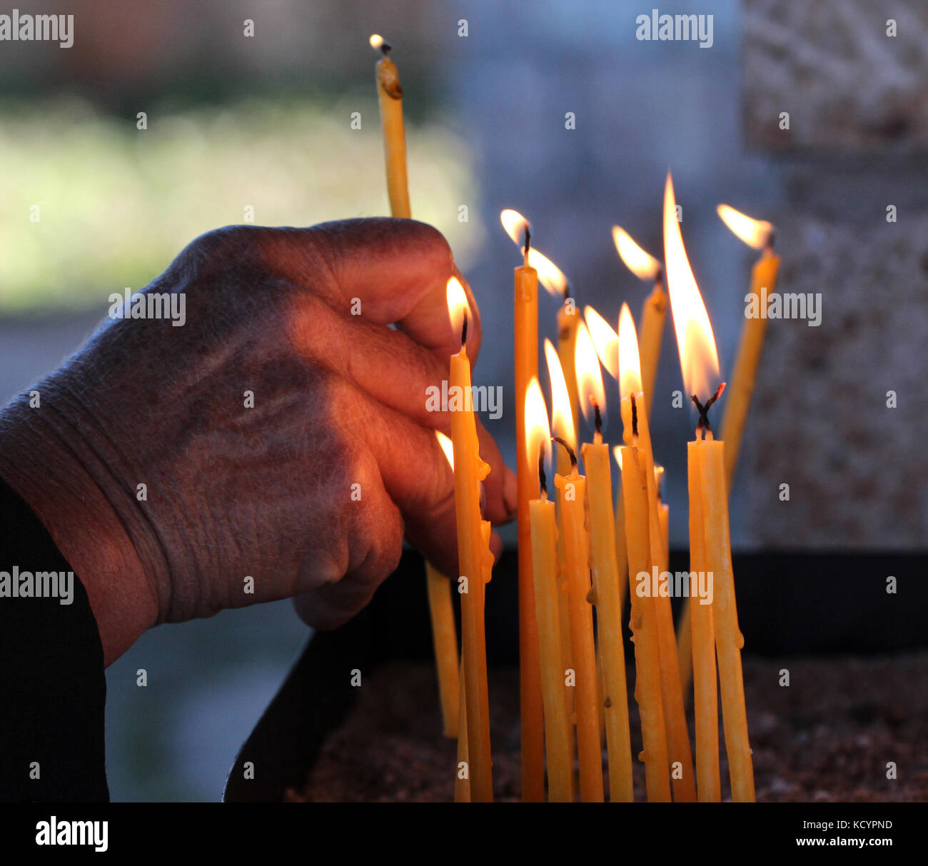 picture of a old man lights a candle Stock Photo - Alamy