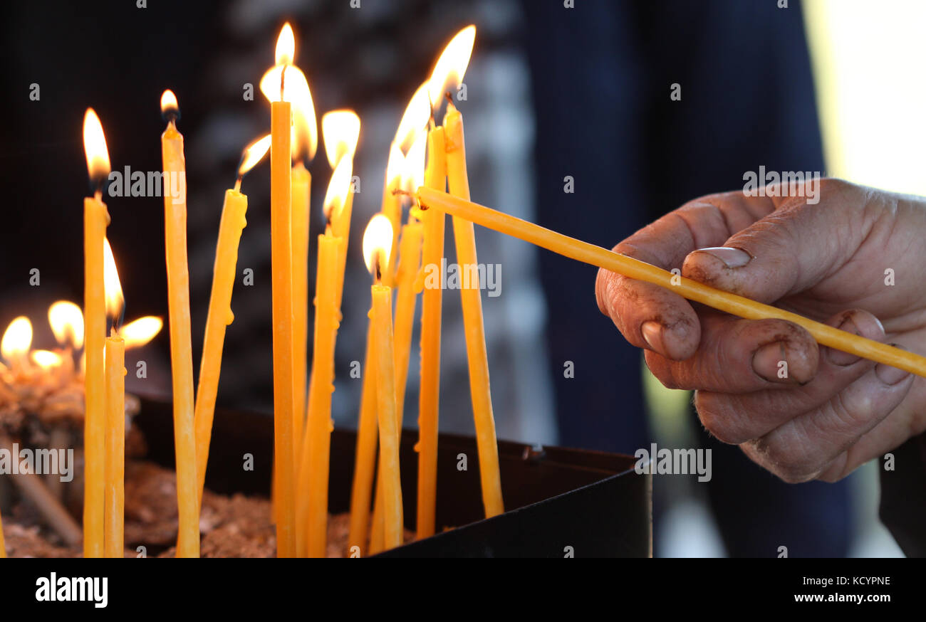 picture of a old man lights a candle Stock Photo - Alamy