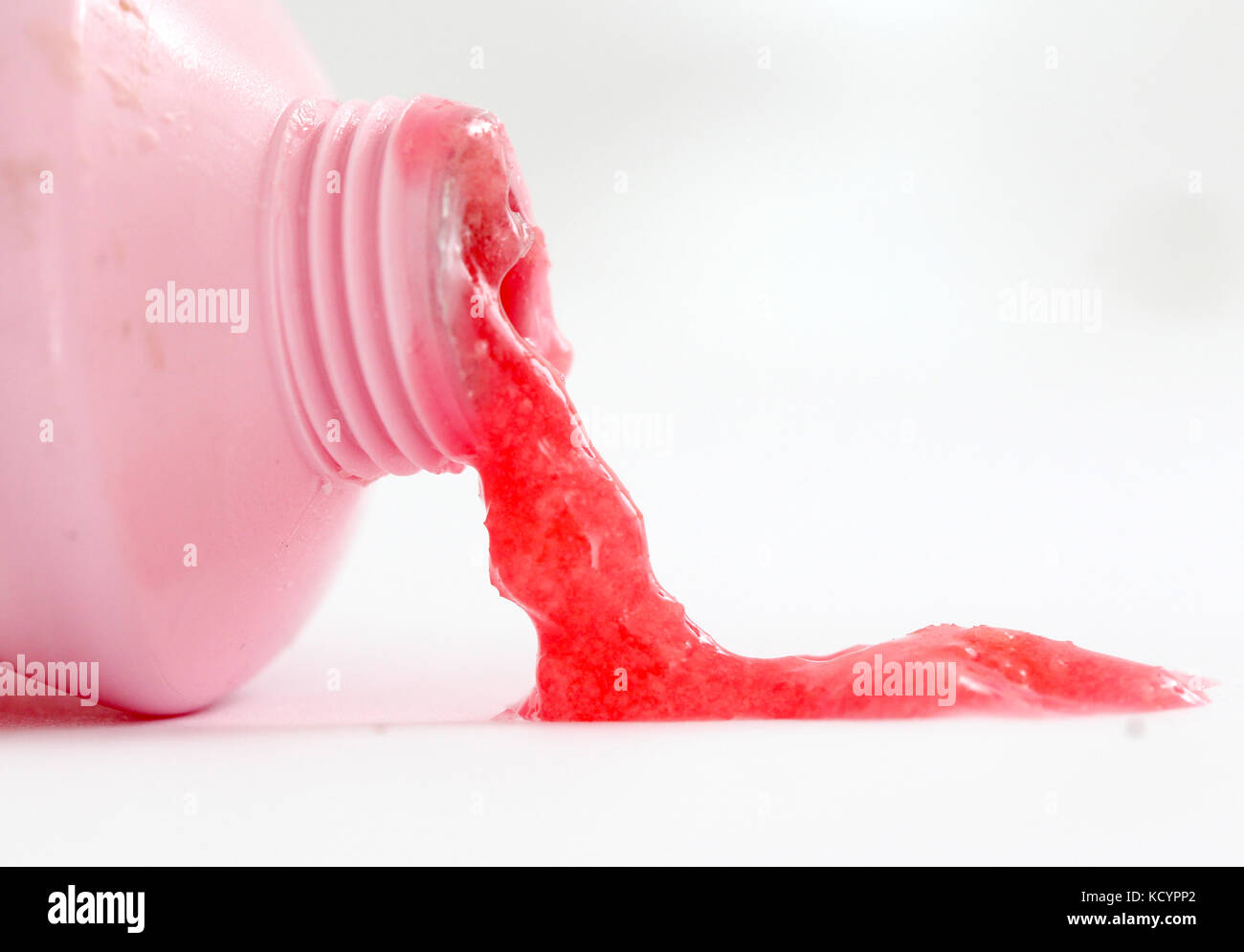 chewing gum with strawberry flavor flows out from tube on white Stock ...