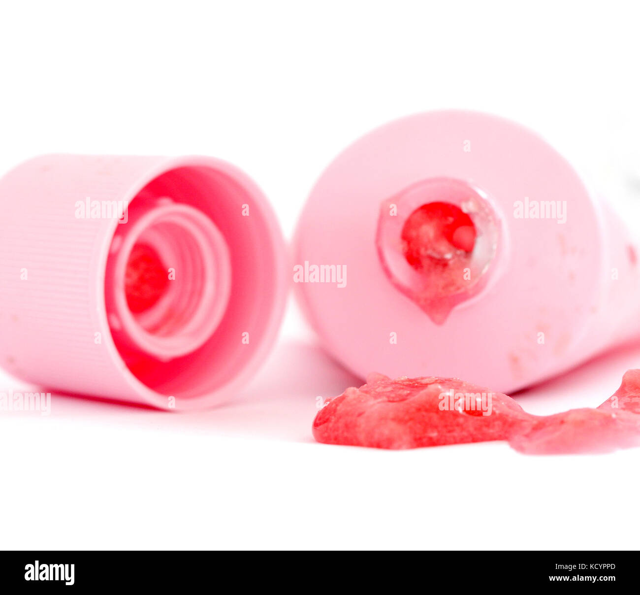 chewing gum with strawberry flavor flows out from tube on white Stock ...