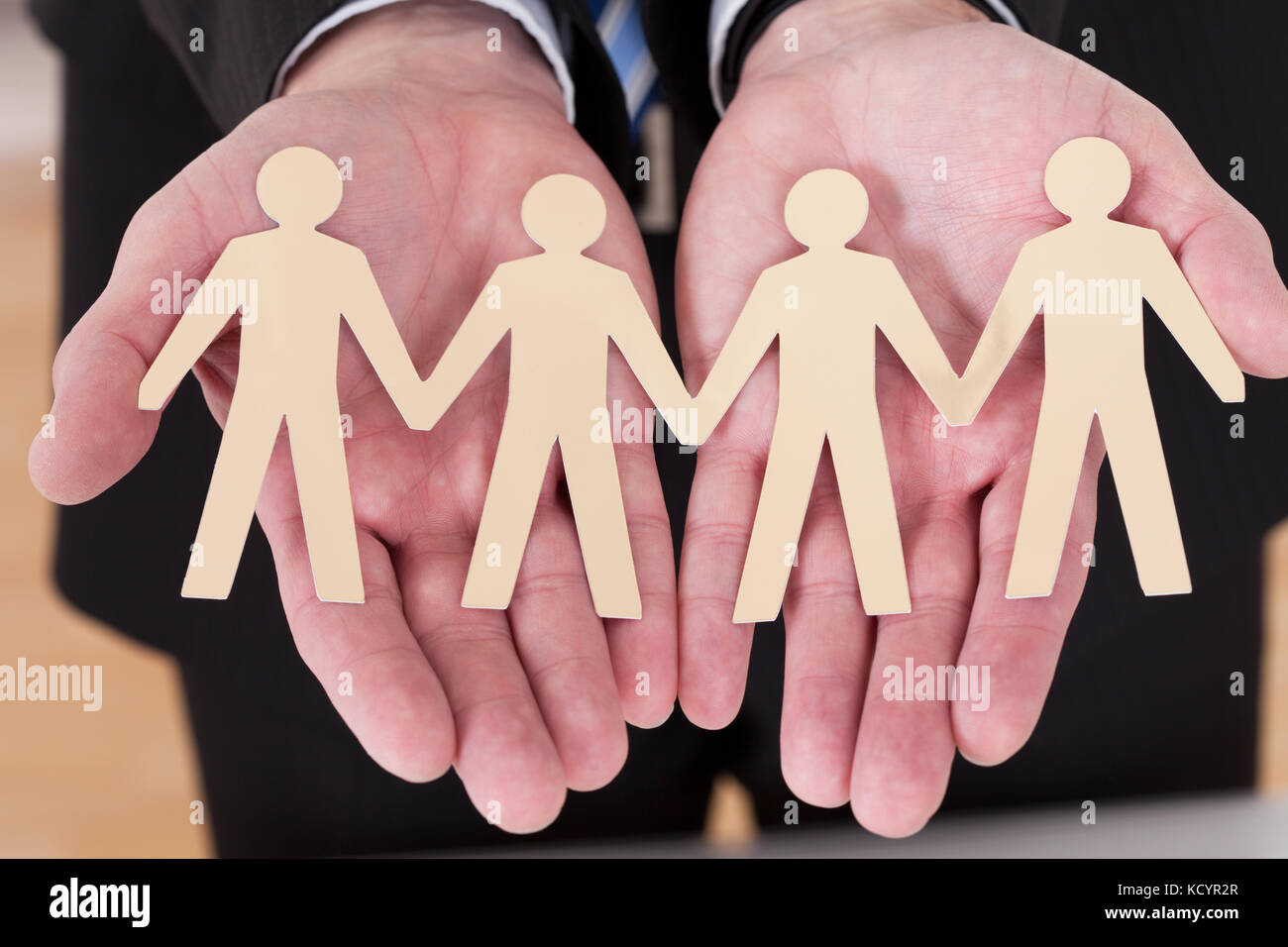 Close-up Of Male Hand Holding Human Figure Cutout Stock Photo - Alamy