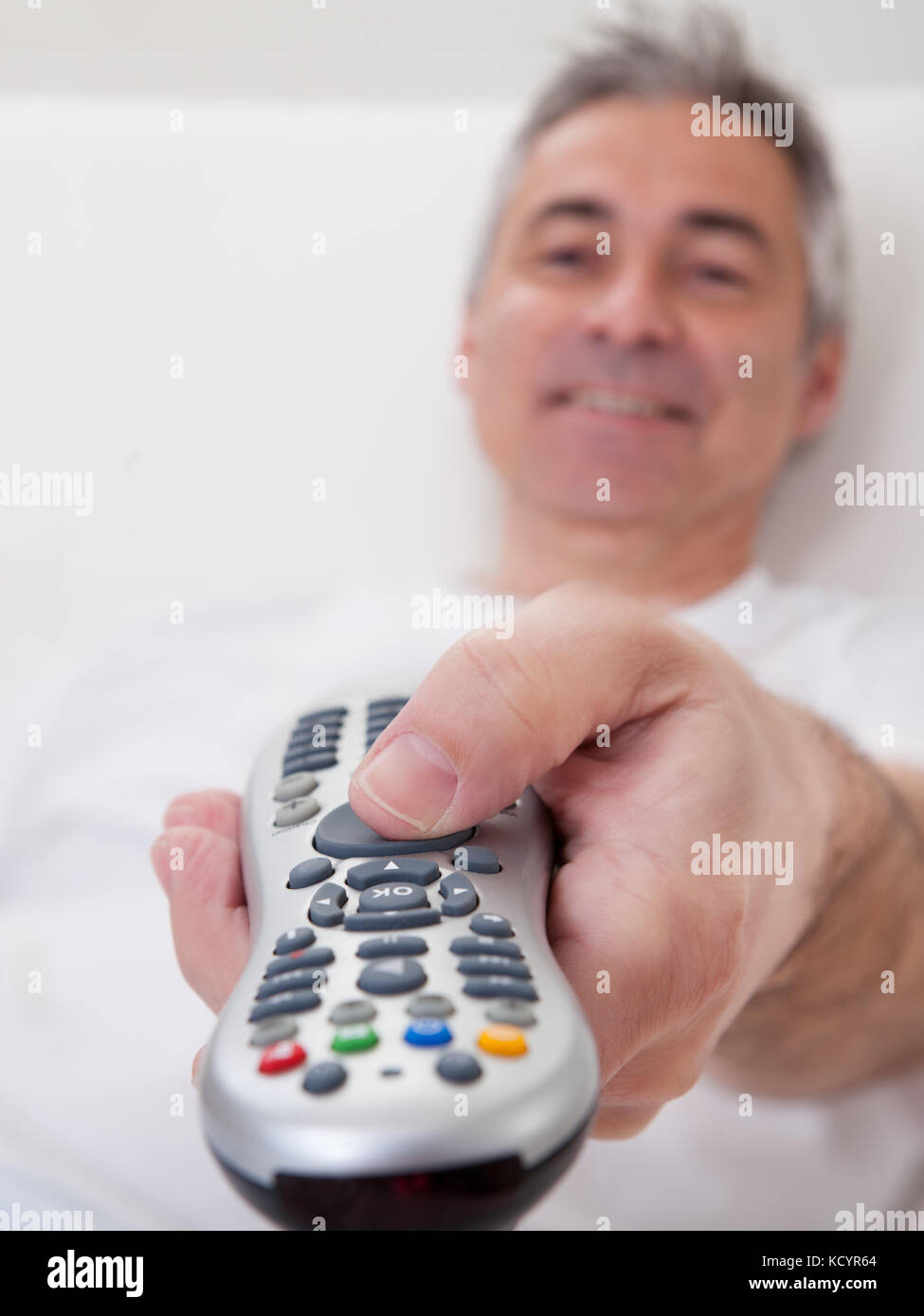 Portrait Of Happy Mature Man Holding Remote Control Stock Photo - Alamy