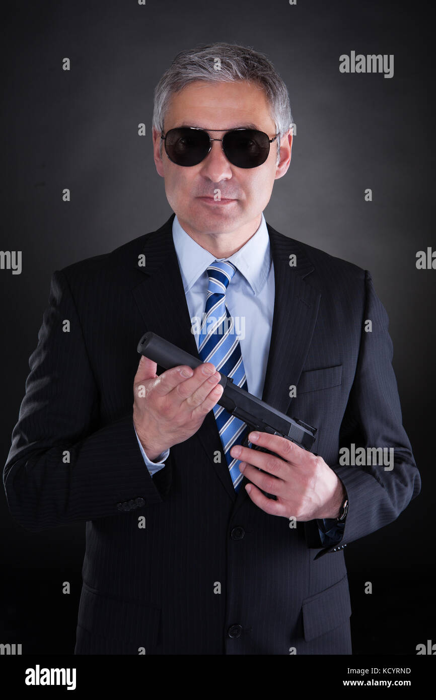 Close-up Of Male With Handgun Over Black Background Stock Photo - Alamy