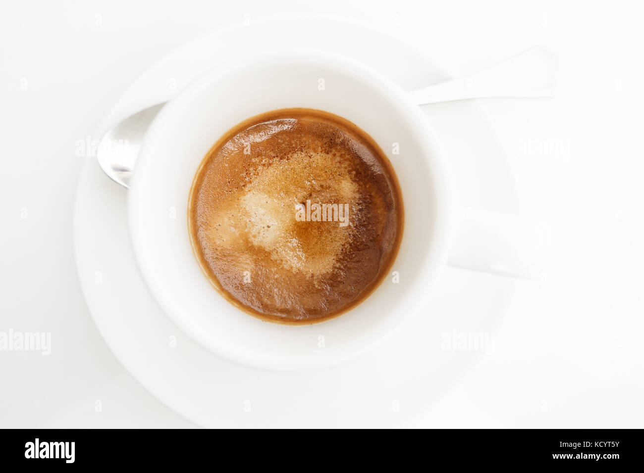 Top view of espresso coffee in white cup on white table. High key style ...