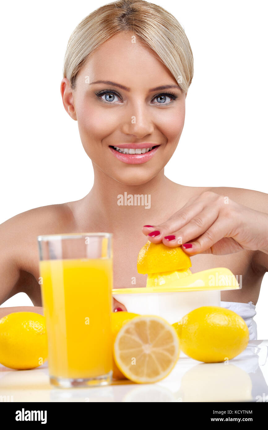 Beautiful young woman making fresh lemonade Stock Photo - Alamy